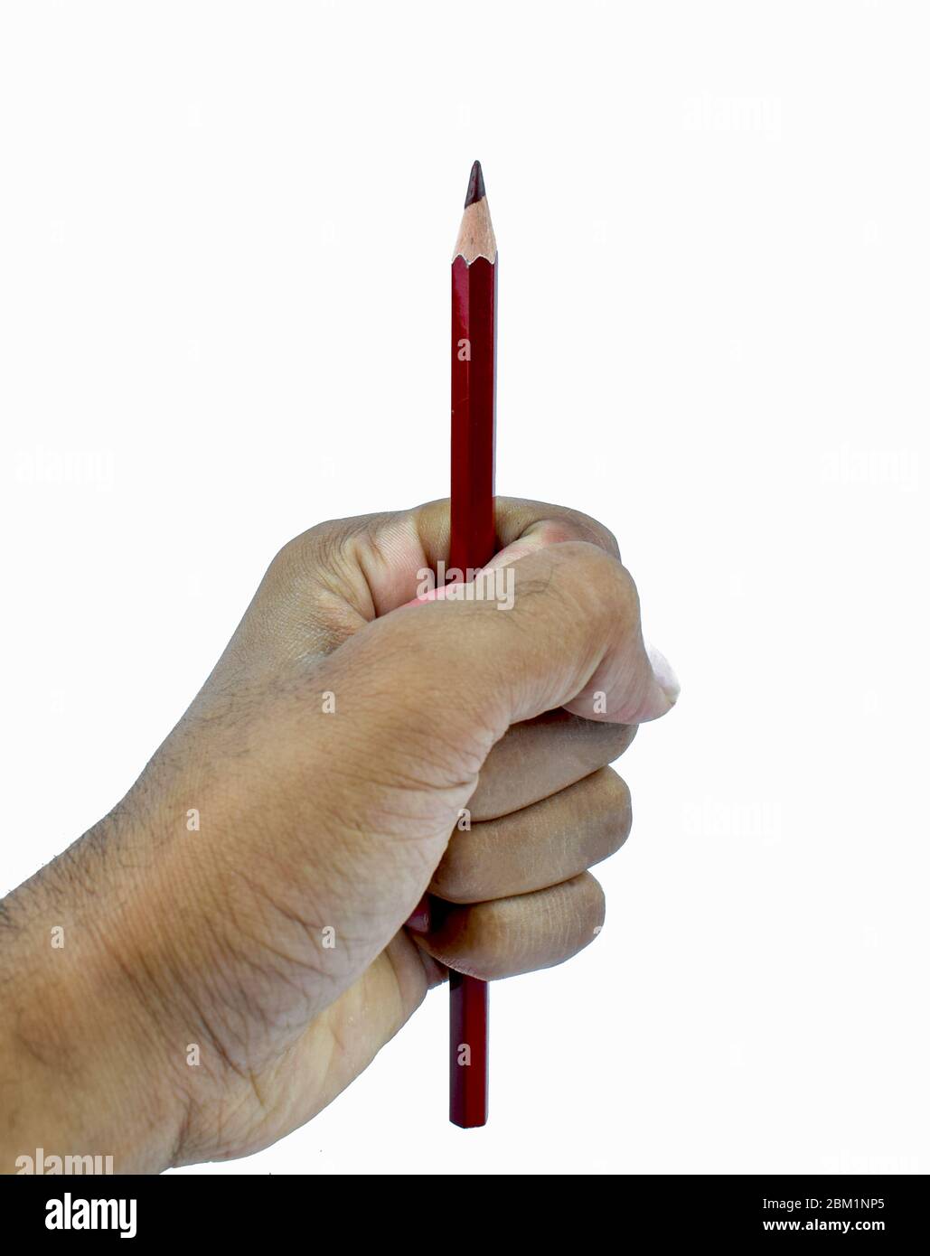 Person holding holding a dark brown colored wood pencil crayon in his ...