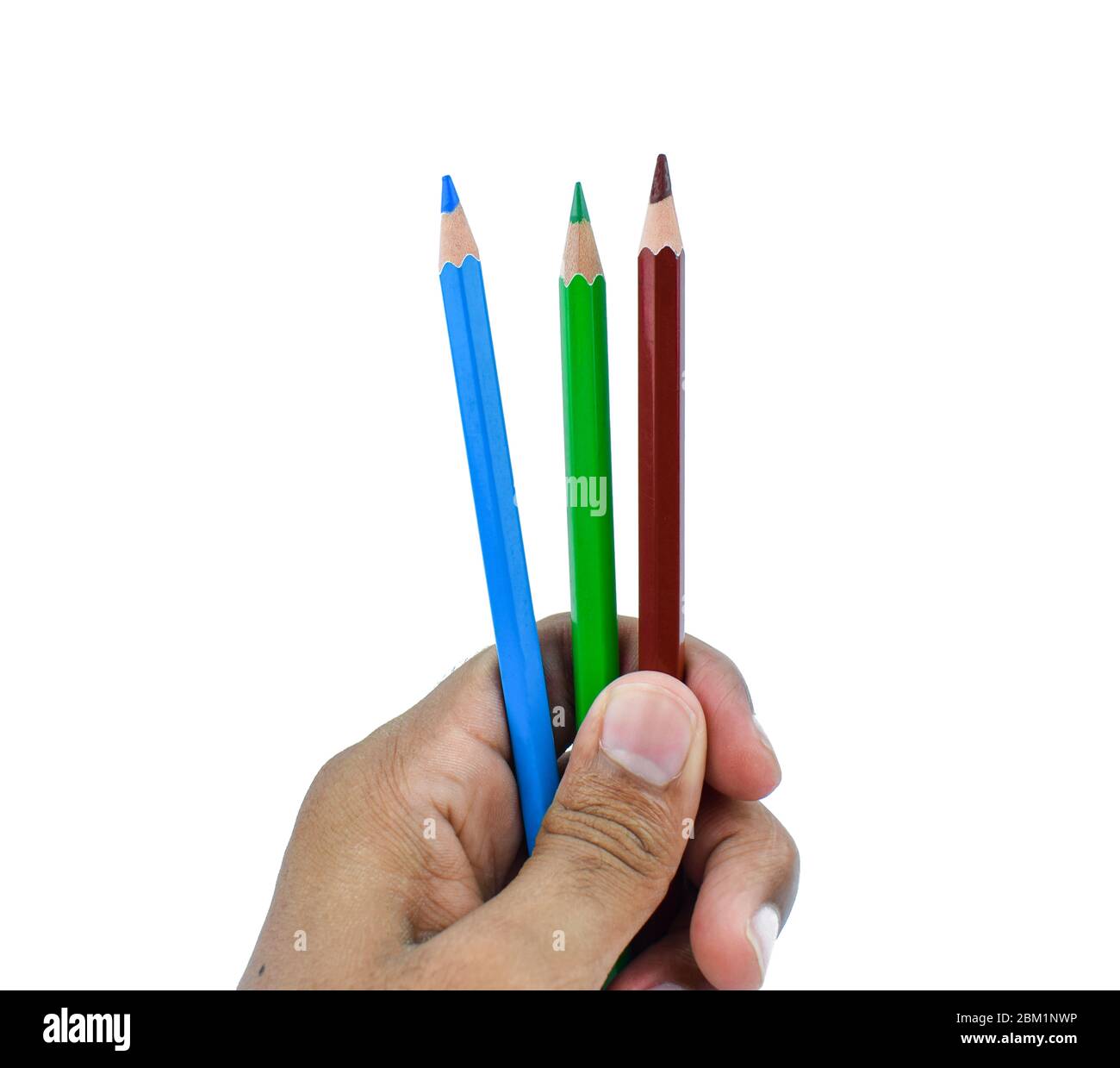 person holding three different color wood pencil crayons with his ...