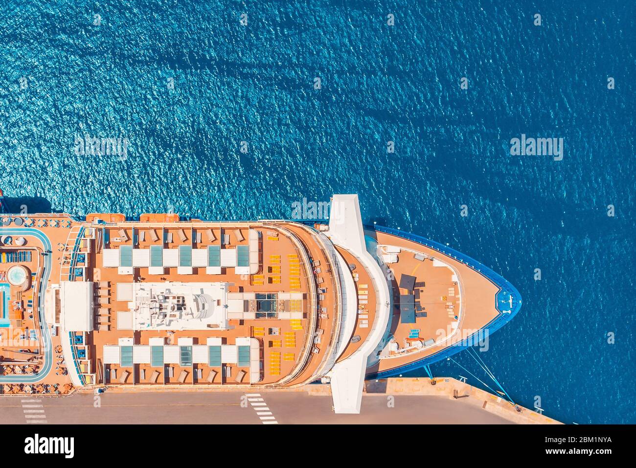 Cruise liner luxury ship in berth port, blue sea water. Top aerial view ...
