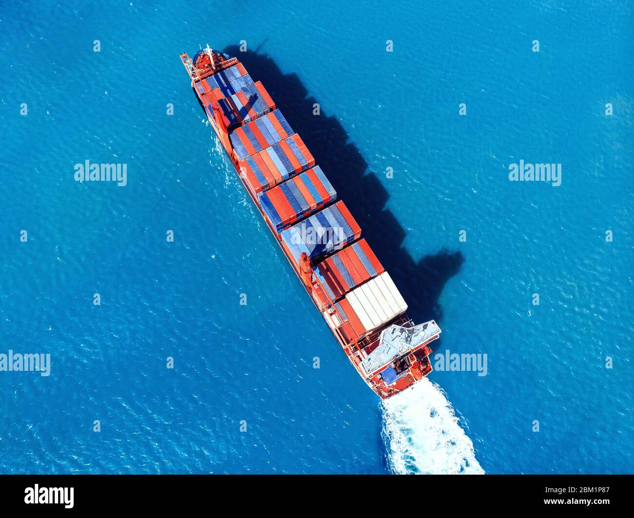 Cargo Ship Transporting Containers Import Export To Port On Background Of Blue Sea Top View