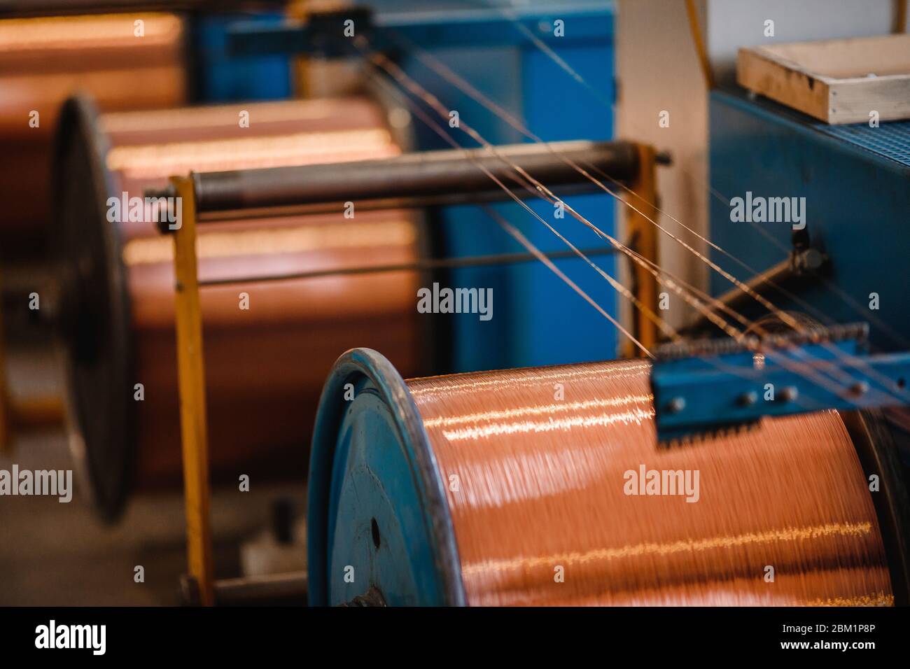Production of copper wire, bronze cable in reels at factory Stock Photo ...