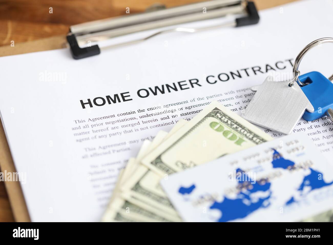 Filling out document that says home owner contract Stock Photo - Alamy