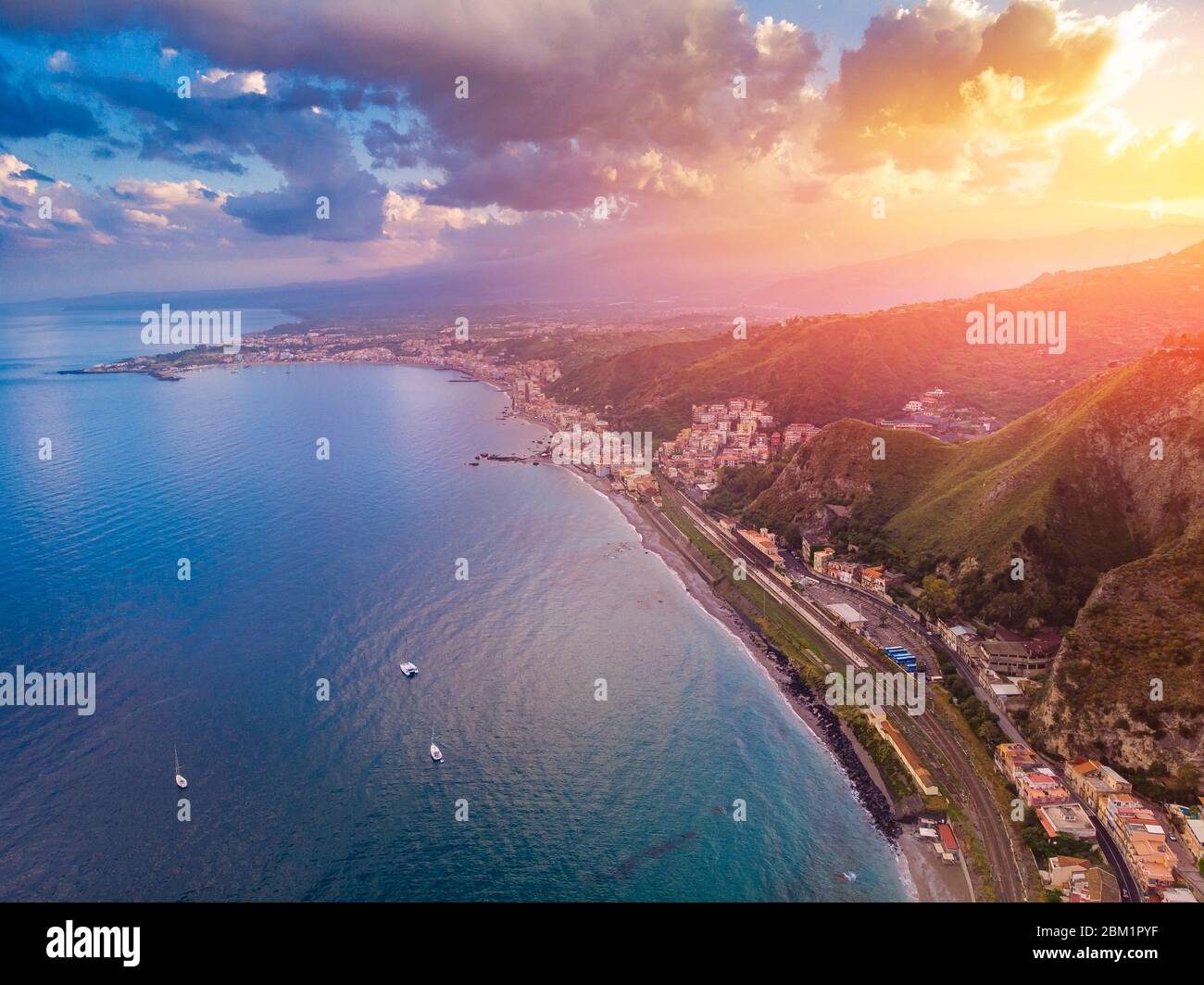Taormina, Sicily Italy sunset, volcano Etna in clouds. Aerial top view ...