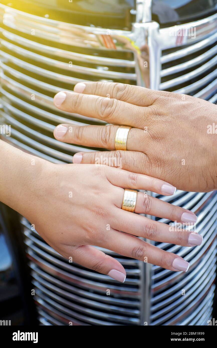 grooms hands joined using wedding rings - golden wedding rings Stock ...