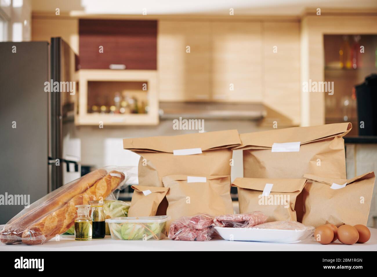 Kitchen counter with meat, bread and food packed in paper bags Stock ...