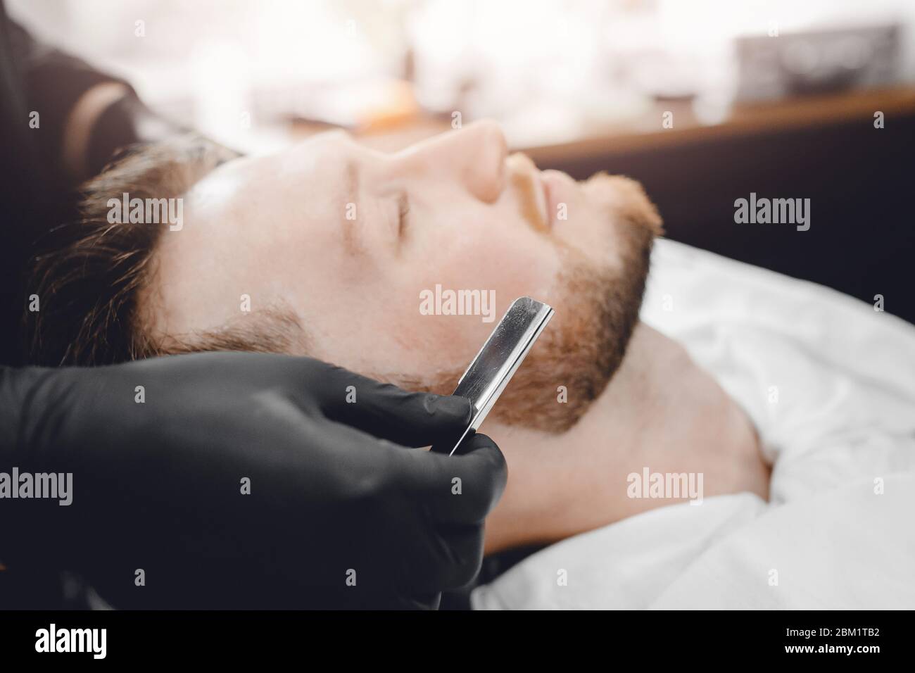 Barbershop. Hairdressers barber hair and beard with razor in salon ...