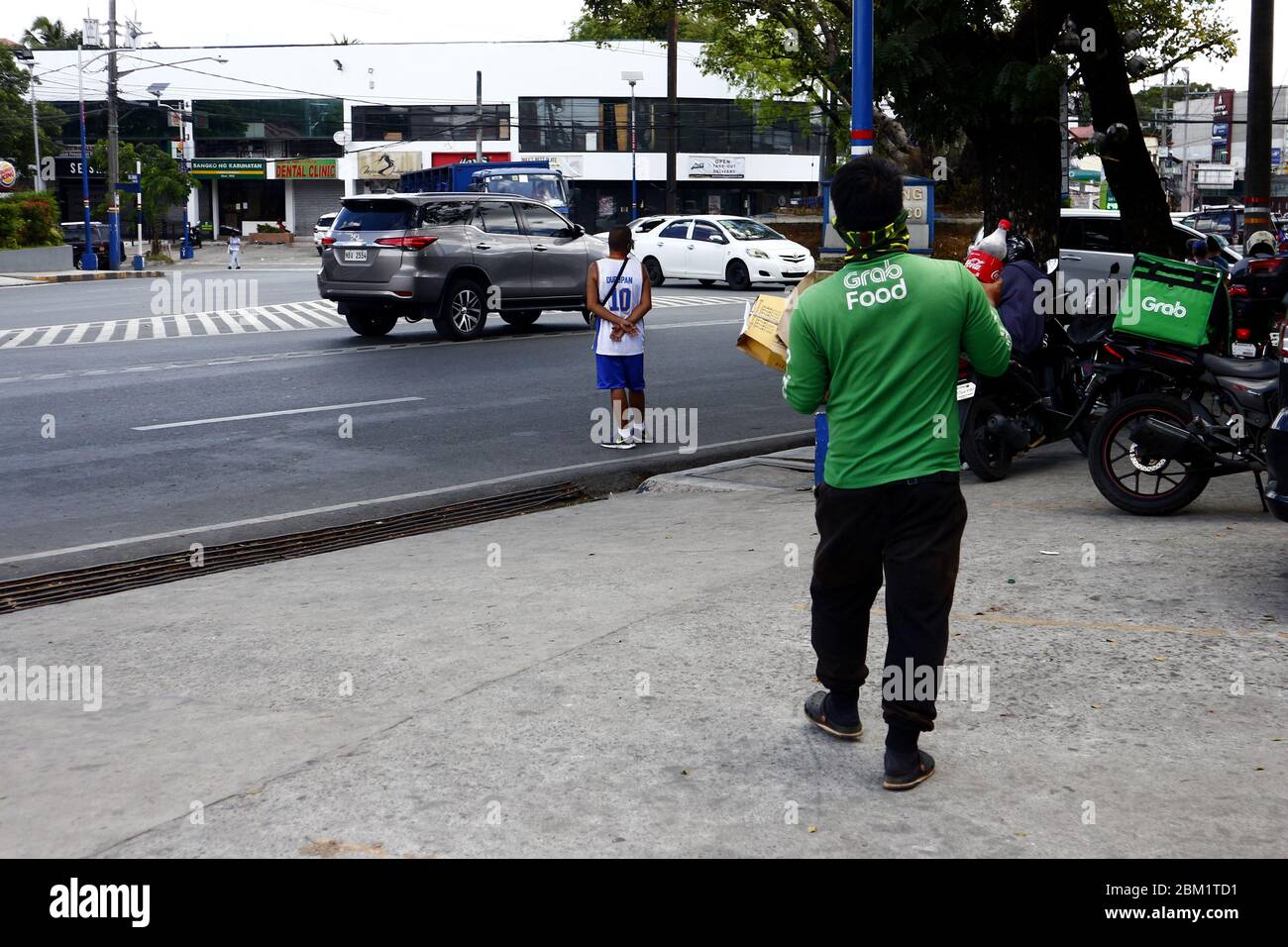 Antipolo City, Philippines - May 5, 2020: Grab food rider carrying a ...