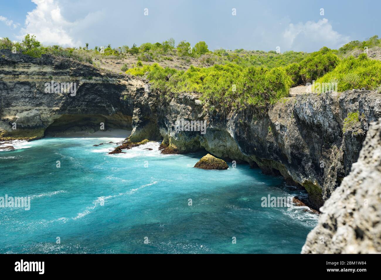 (Selective focus) Stunning view of a rocky cliff bathed by a turquoise ...