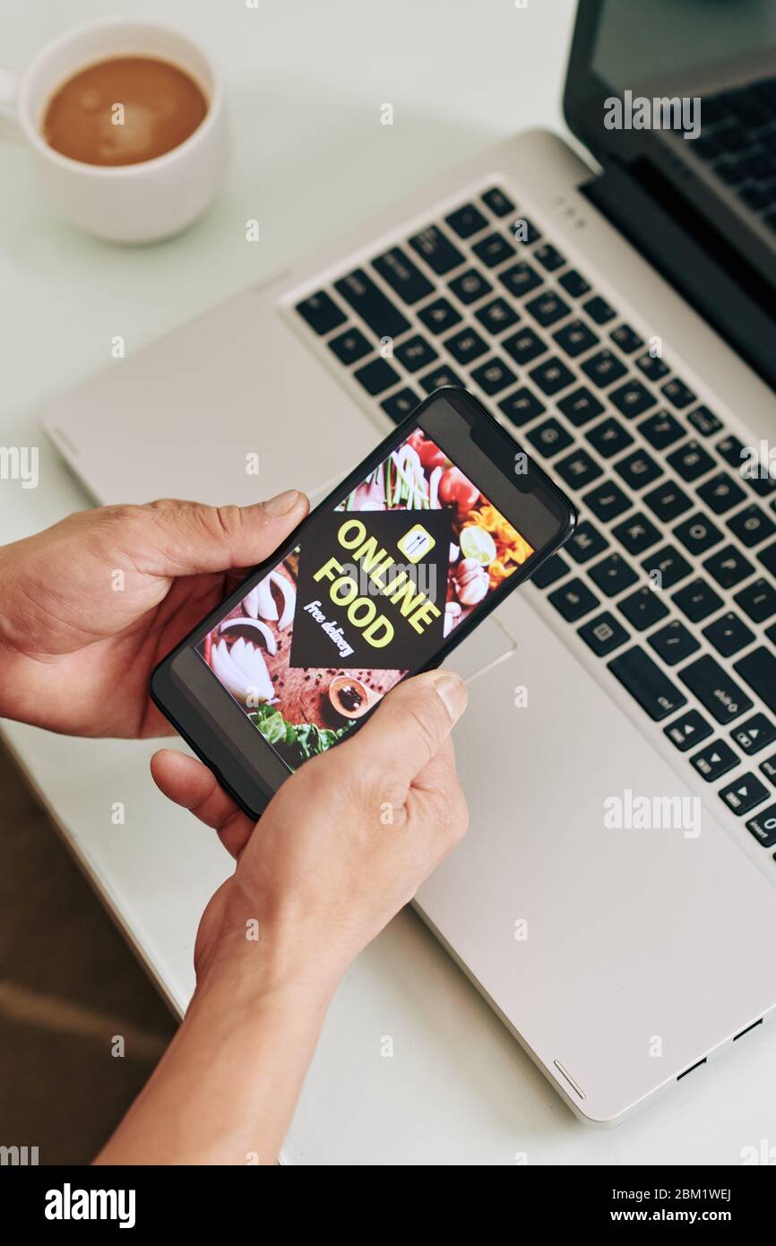 Using smartphone order food from hi-res stock photography and images ...