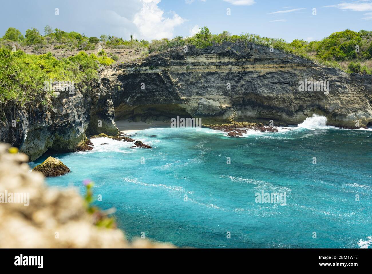 (Selective focus) Stunning view of a rocky cliff bathed by a turquoise ...