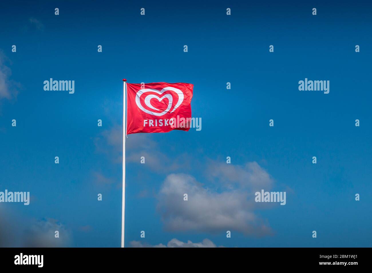 Kalo, Denmark - 01maj 2020: Red Frisko flag with blue sky as background ...