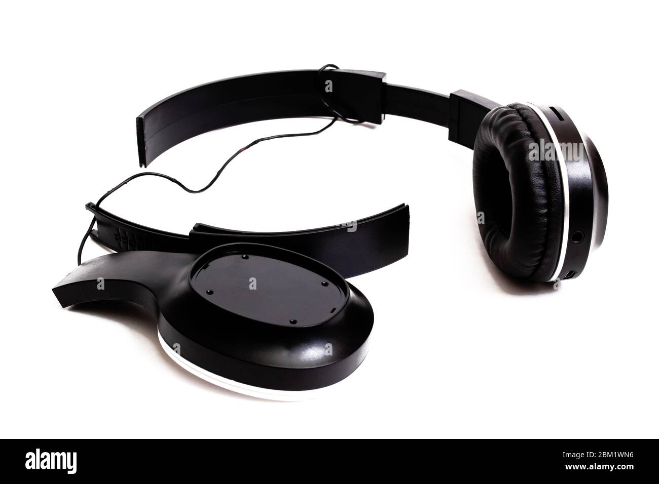 Broken black headphones isolated on white background Stock Photo - Alamy