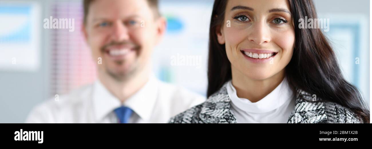 Smiling employees man and woman stand in office Stock Photo - Alamy