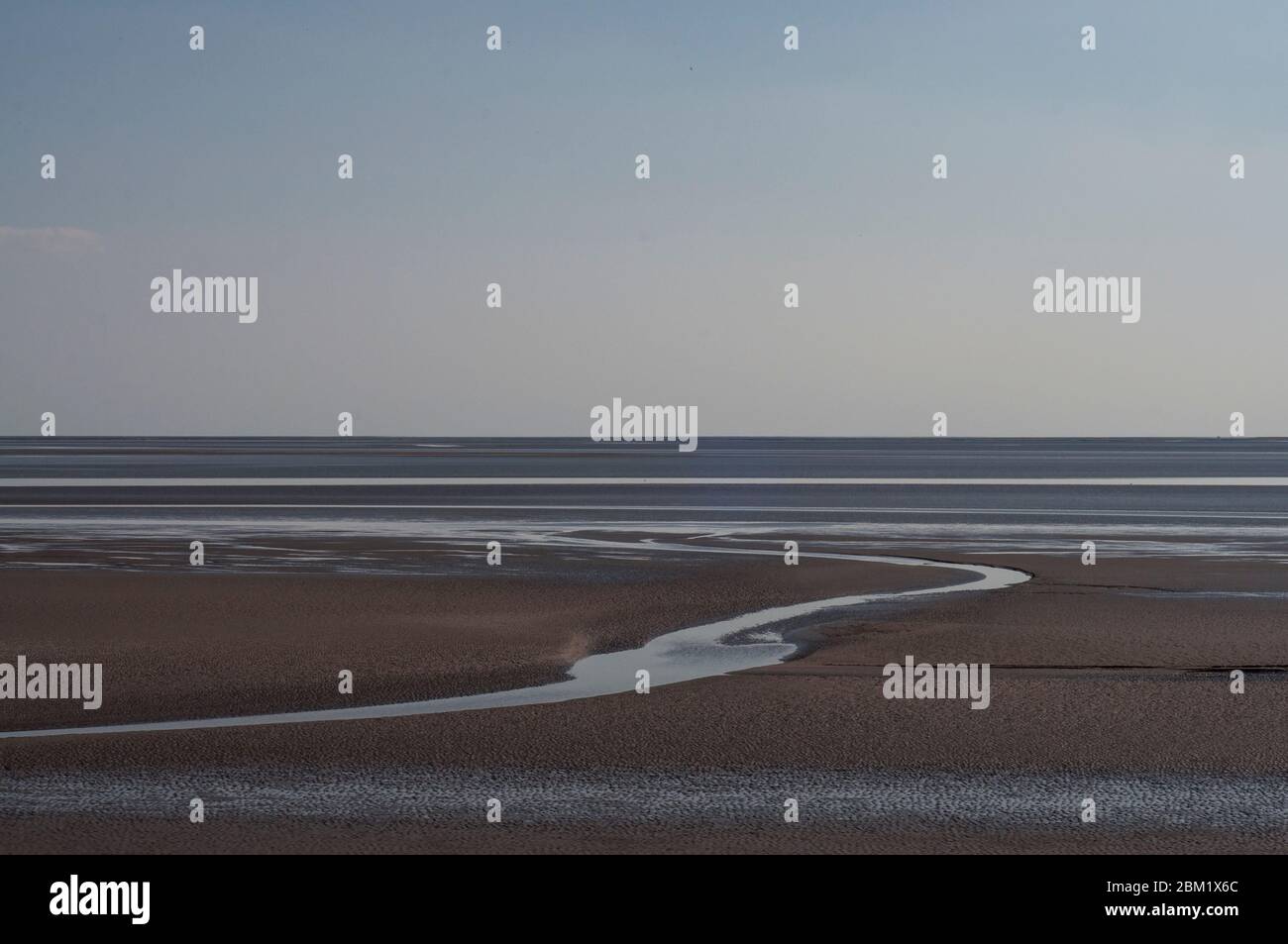 sand shore with water channels during low tide Stock Photo - Alamy