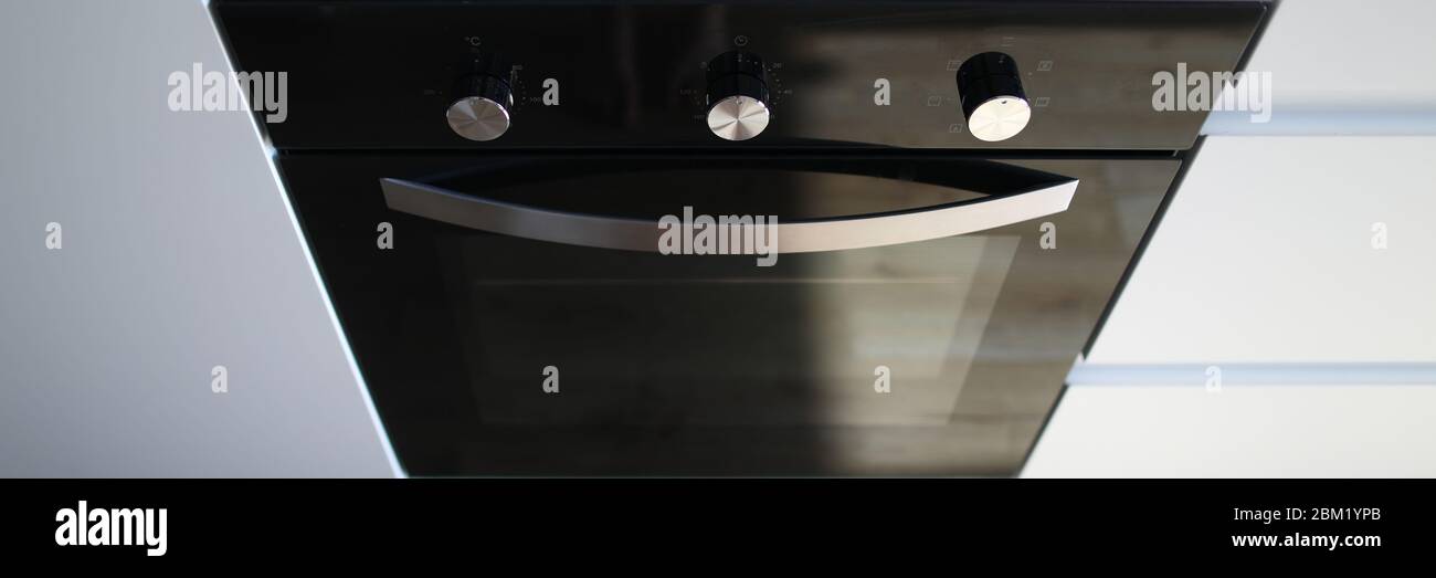 Close-up steel oven built into kitchen surface Stock Photo - Alamy
