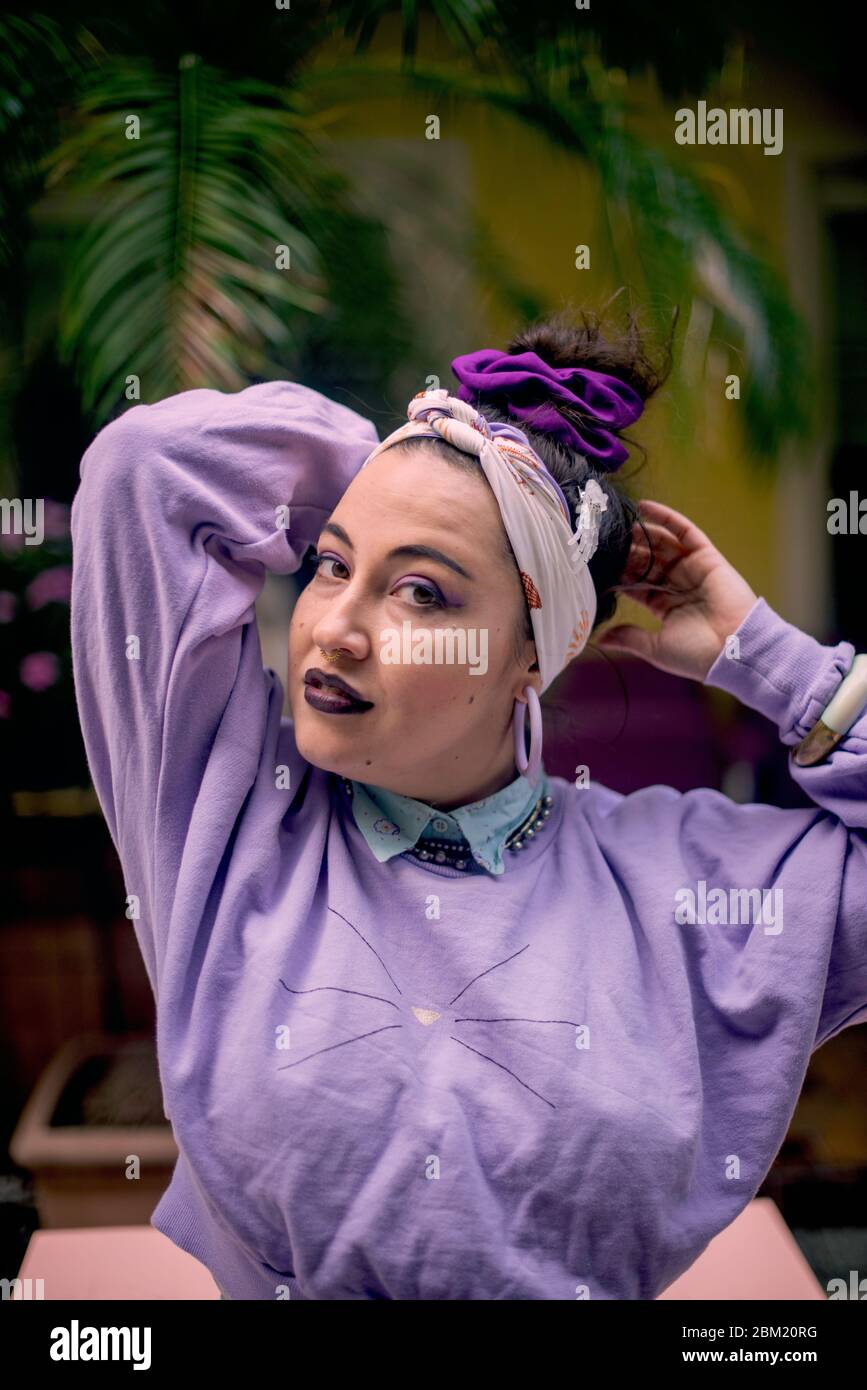 Portrait of beautiful woman posing and looking in direction of camera ...