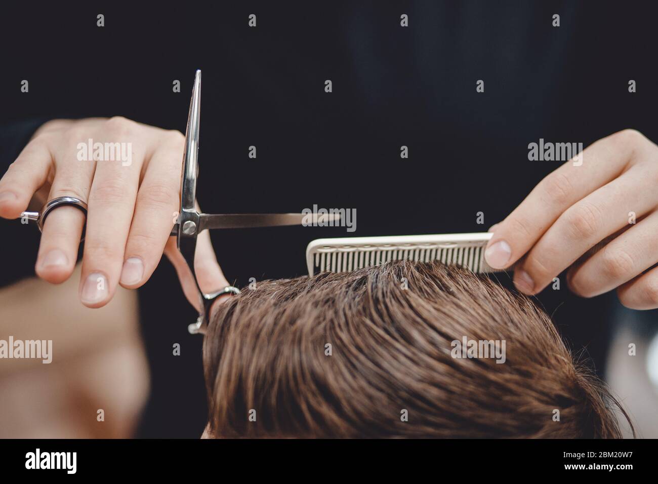 Barbershop, man barber in men hairdresser does hair with scissors Stock ...