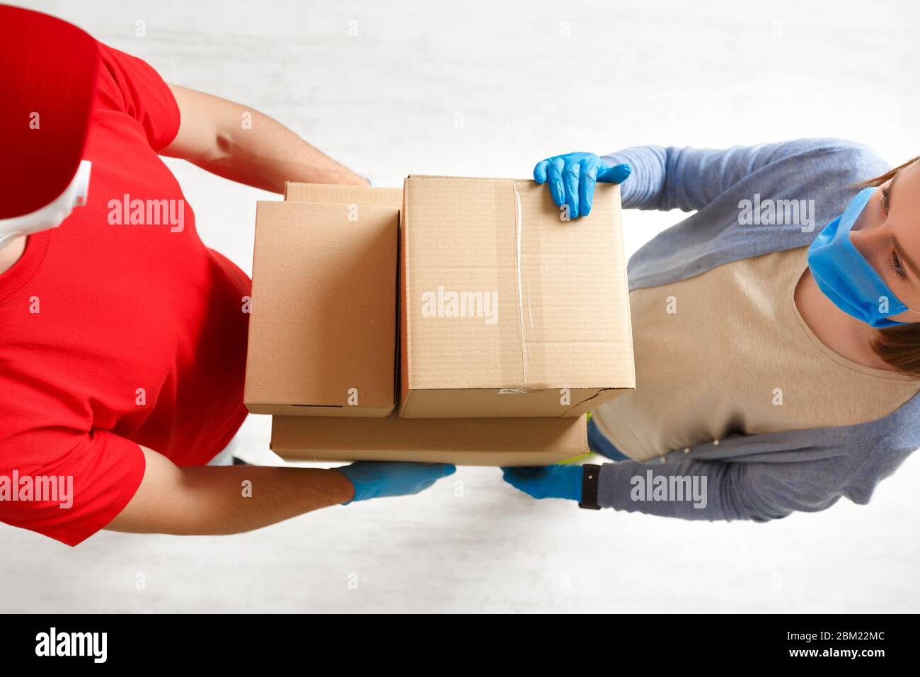 Client picks up a lot of parcels from courier Stock Photo - Alamy