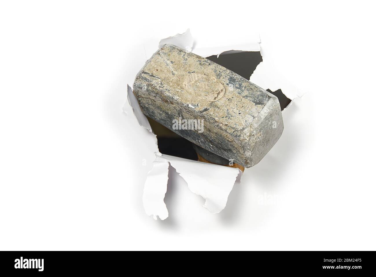 close-up hammer through a torn white paper, isolated. Hammer punching ...