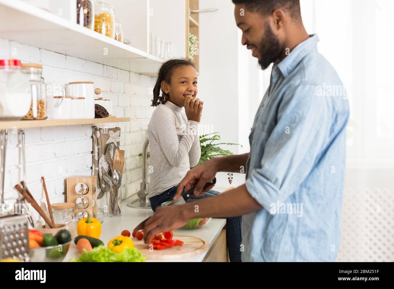 Father and daughter preparing healthy food together at home Stock Photo ...