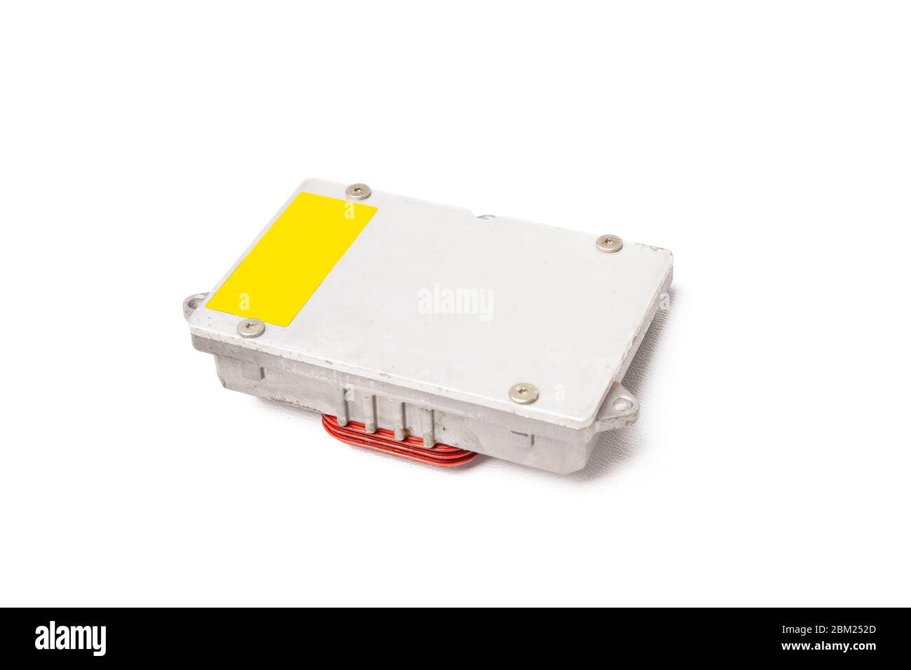Plastic car engine control unit with metal elements on a white isolated ...