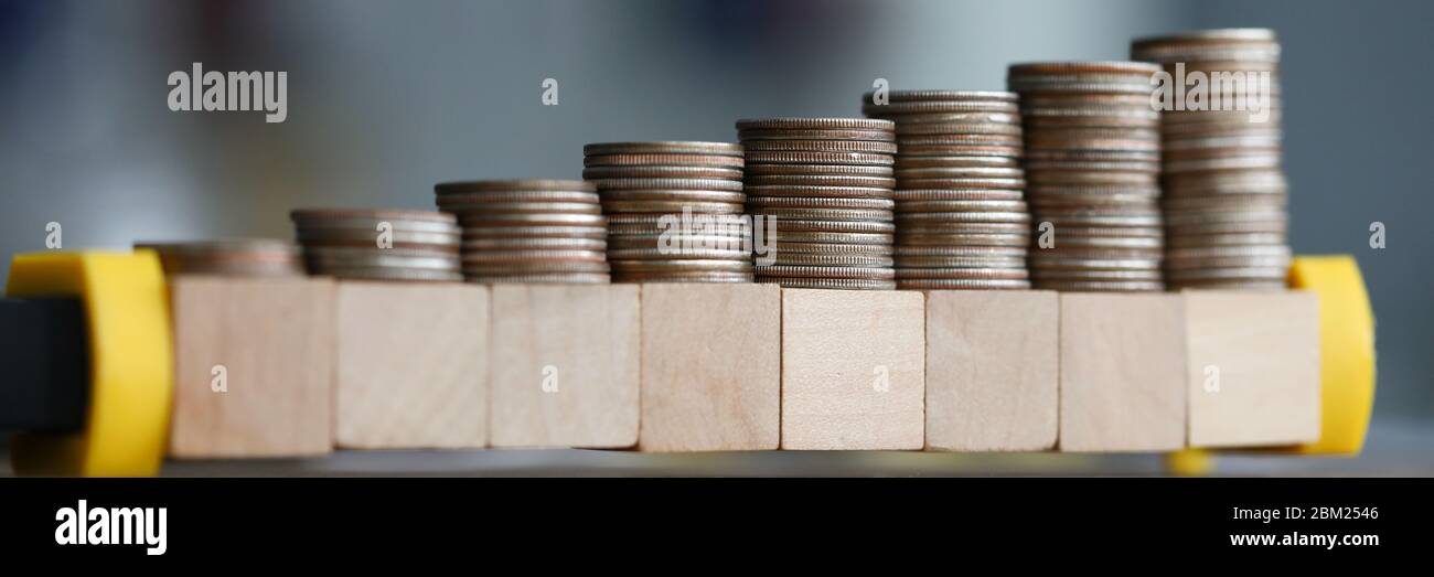Wooden blocks coins money hi-res stock photography and images - Alamy