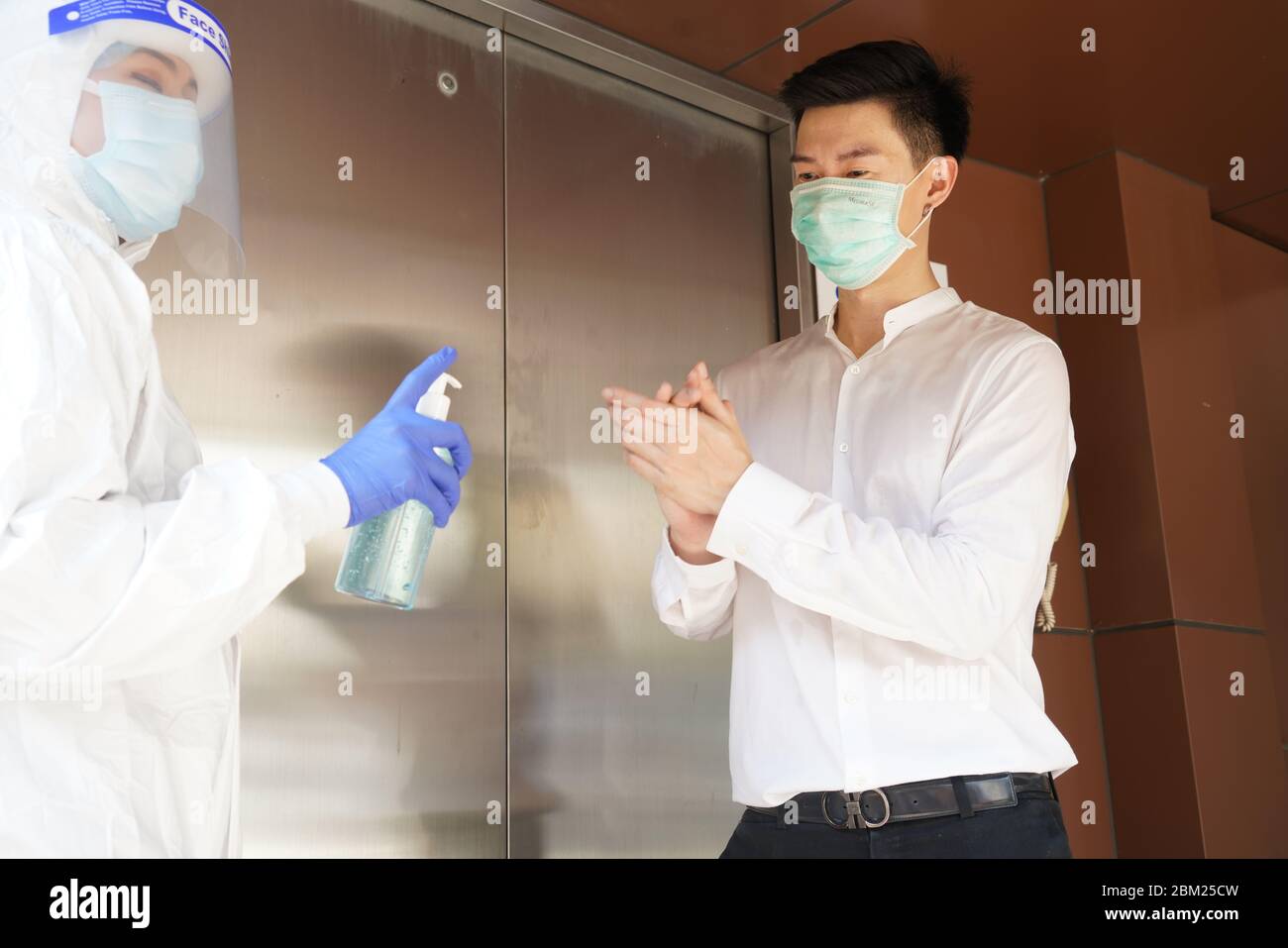 Disease control experts use an Infrared thermometer equipment to check ...