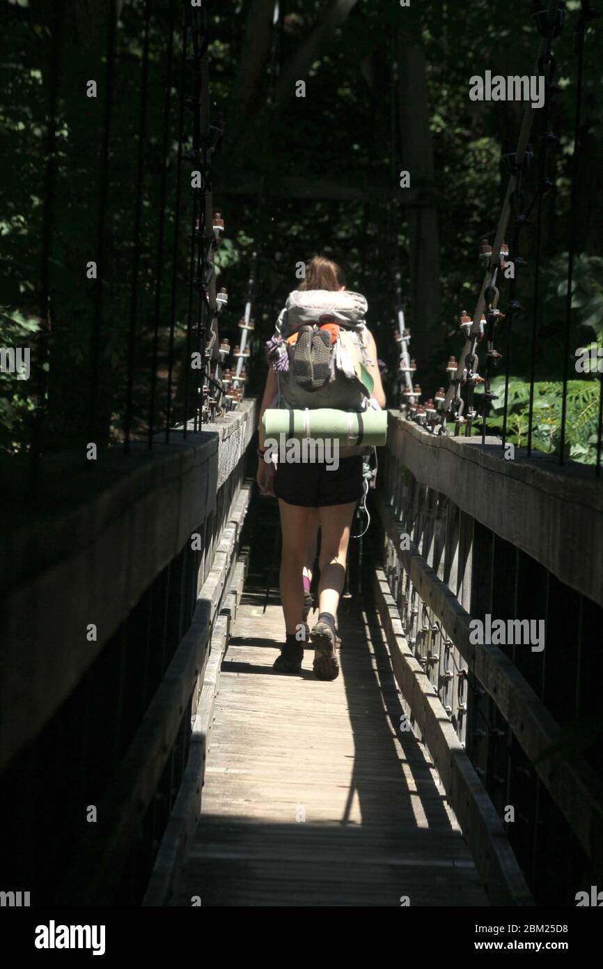 Hikers on swing bridge over Tye River on the Appalachian Trail in ...