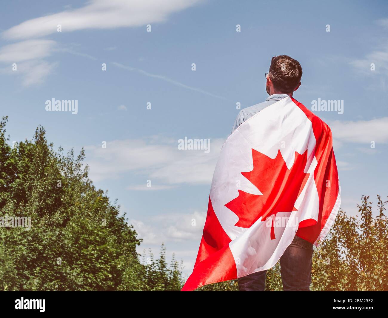 Attractive man holding Canadian Flag. National holiday Stock Photo - Alamy