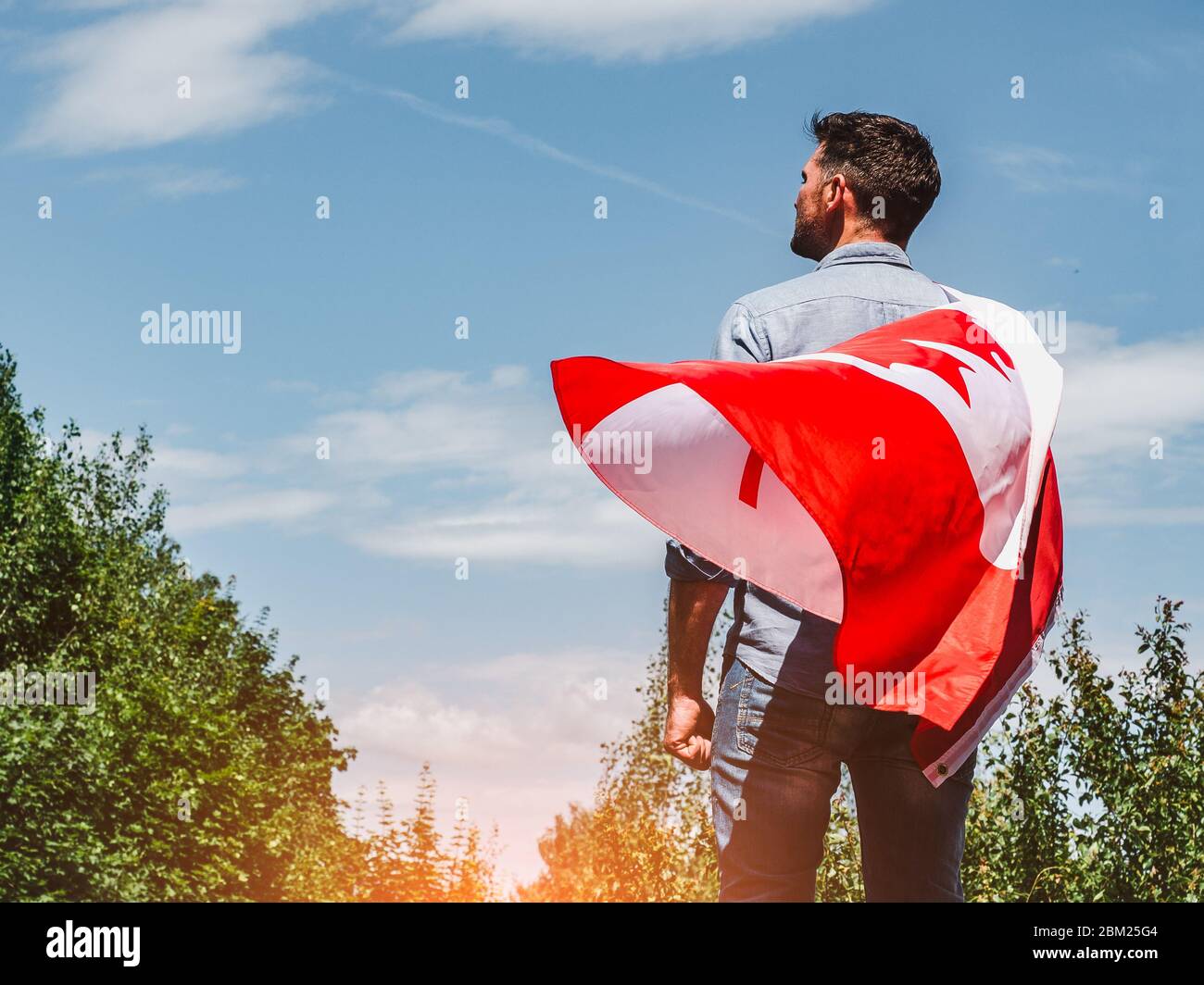 Young man waving canadian flag hi-res stock photography and images - Alamy