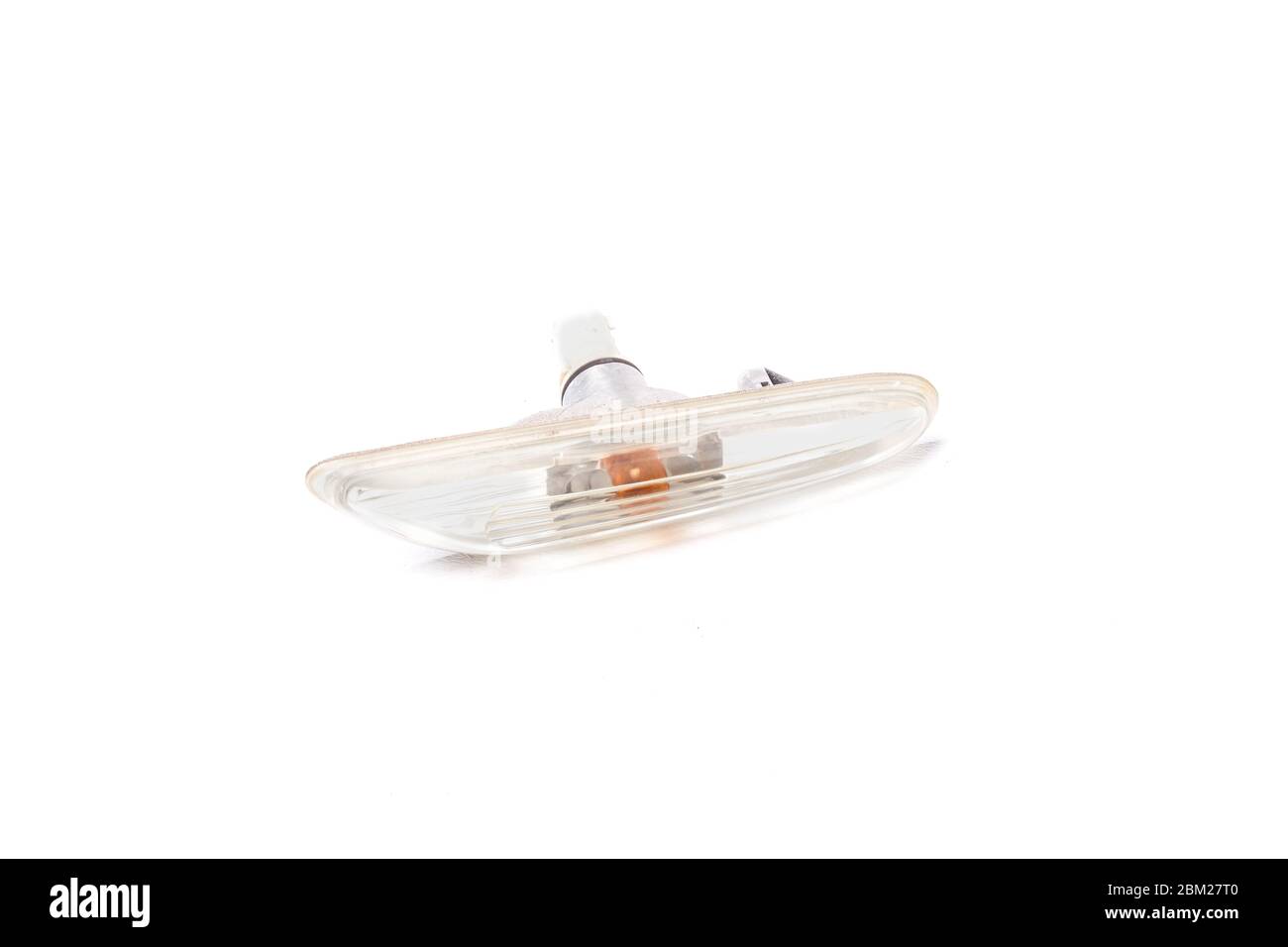 The spare part of the car is a plastic transparent turn signal with a ...