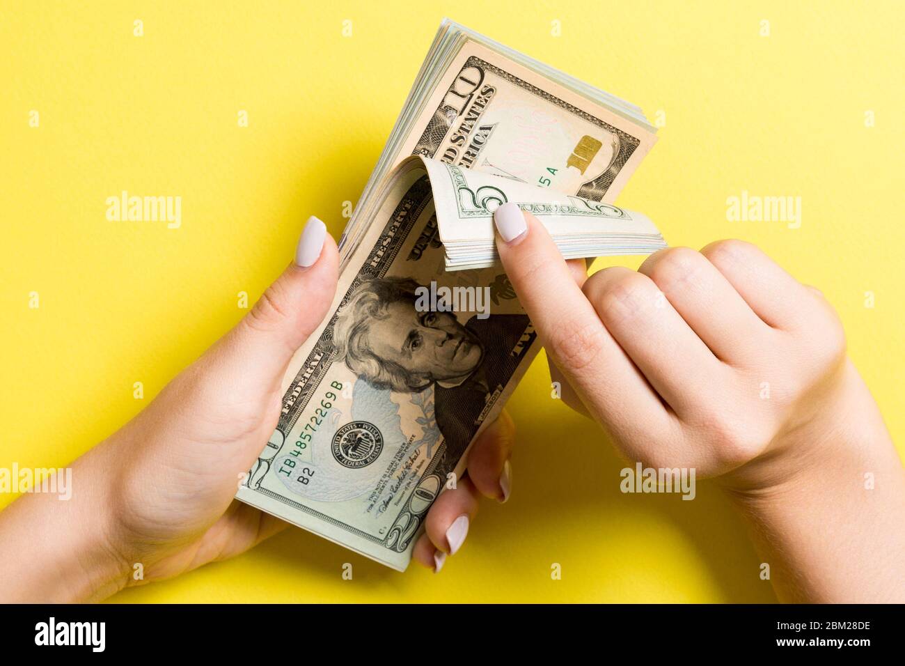 Top view of female hands counting money. Various dollar banknotes on ...