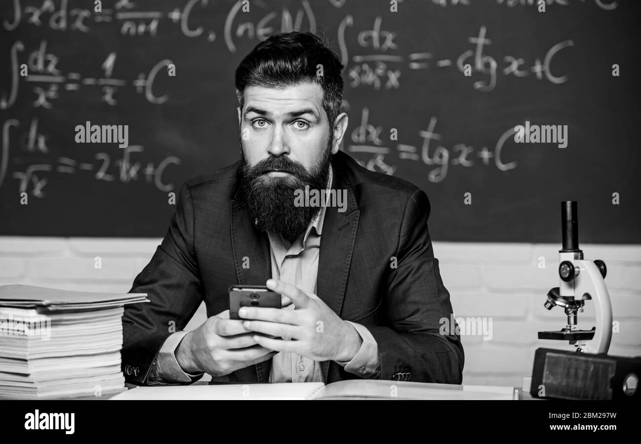 School application. Study technology. School teacher hold mobile phone ...