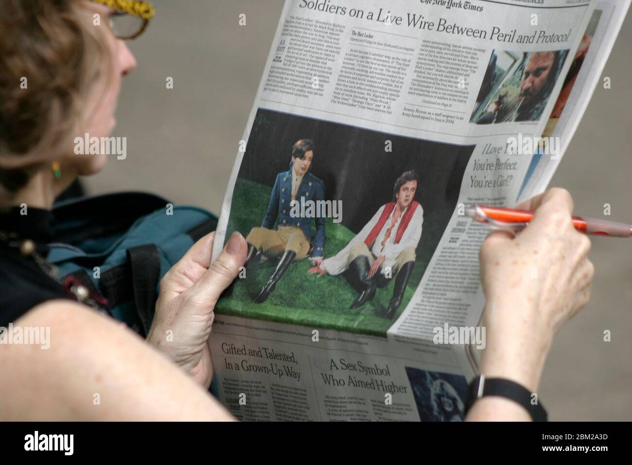 Woman reading the New York Times in Manhattan, NY, USA Stock Photo - Alamy