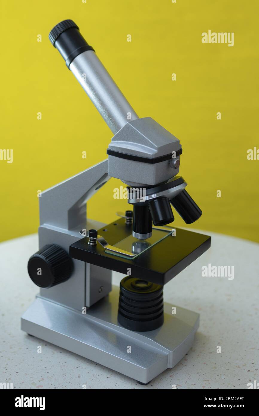 Microscope for biology on a yellow background for learning Stock Photo ...