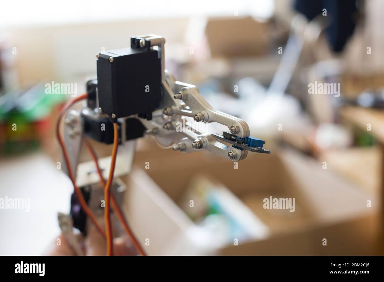 Photo of robot manipulator, which holds the little chip Stock Photo - Alamy