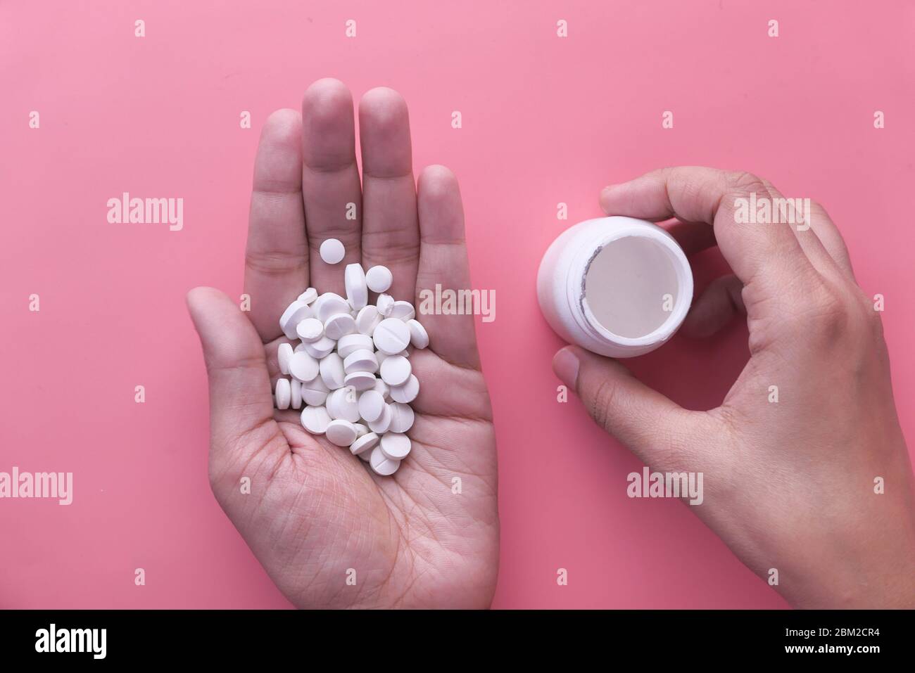 young women pouring pills from bottle on hand Stock Photo - Alamy