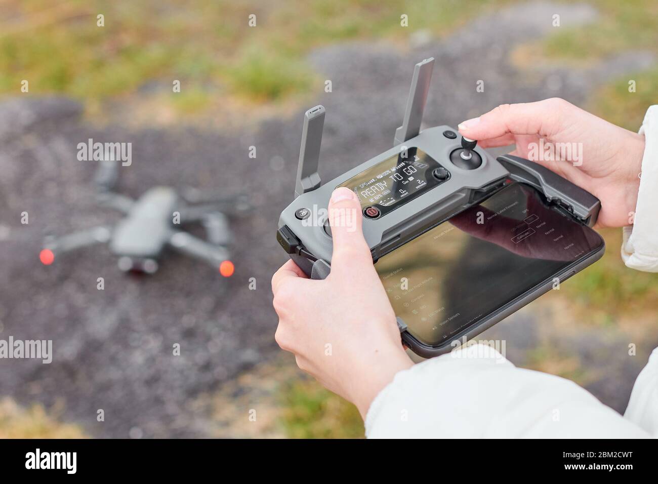Drone is taking off by remote controller in womans hands. Concept of ...