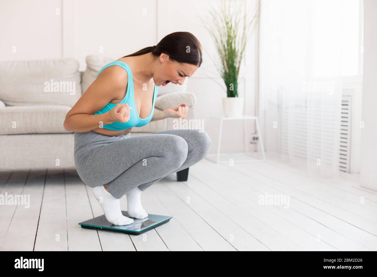 Woman weigh scales unhappy hi-res stock photography and images - Alamy