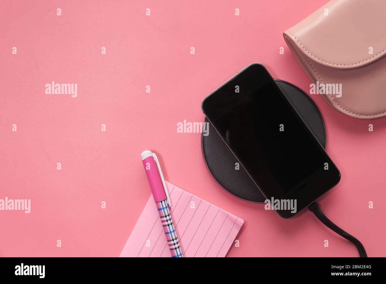 charging Smartphone Using Wireless Charging Pad, top view Stock Photo ...
