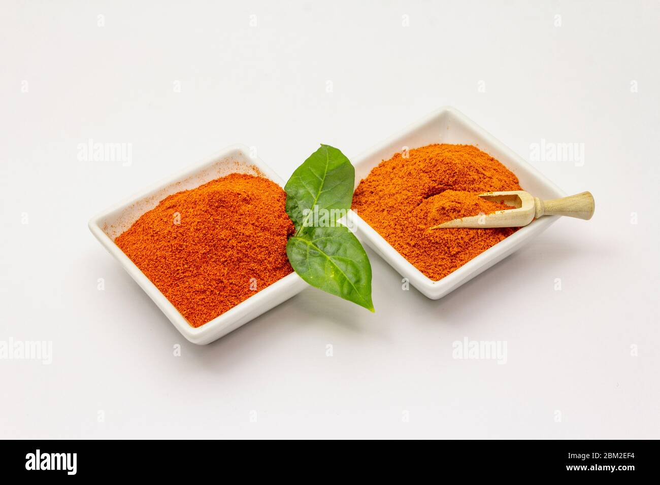 Two types of Hungarian paprika powder, hot and sweet, isolated on white ...