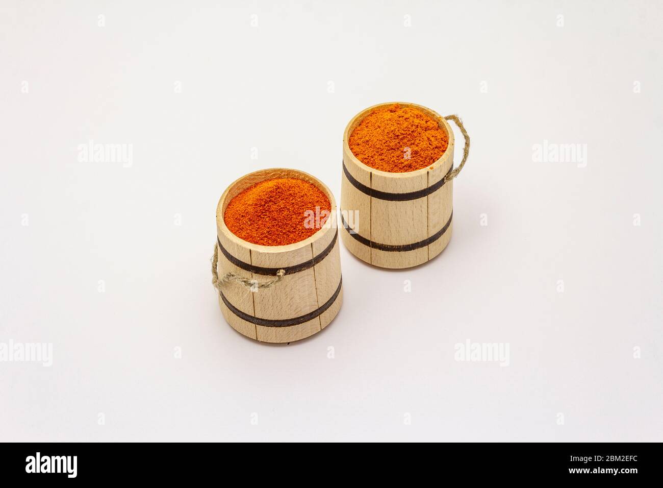 Two types of Hungarian paprika powder, hot and sweet, isolated on white ...