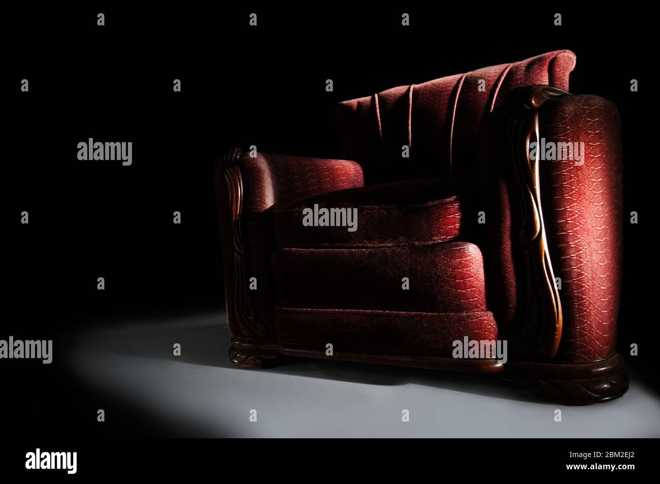 Dramatic red arm chair on black background Stock Photo - Alamy