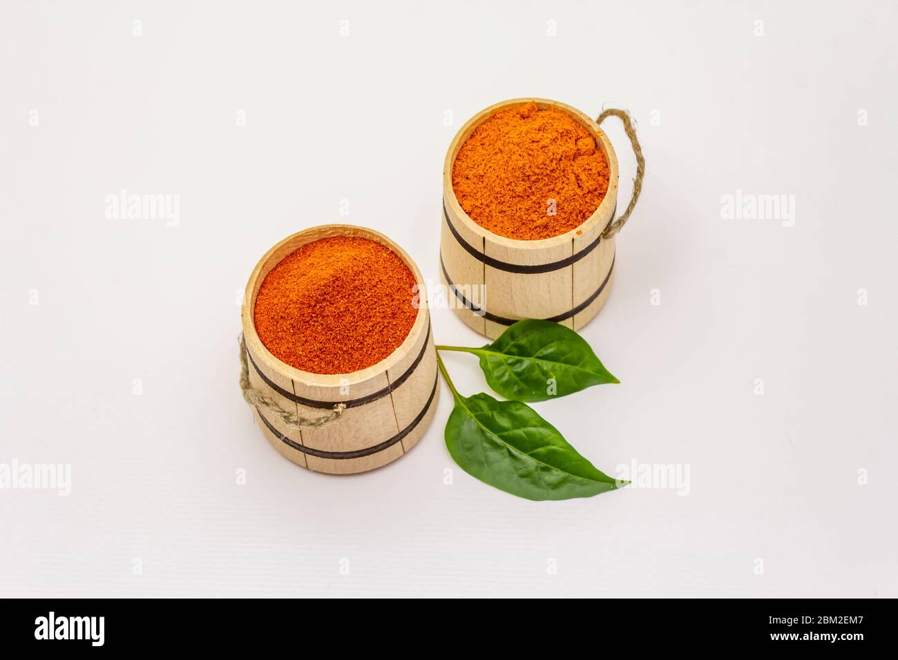Two types of Hungarian paprika powder, hot and sweet, isolated on white ...