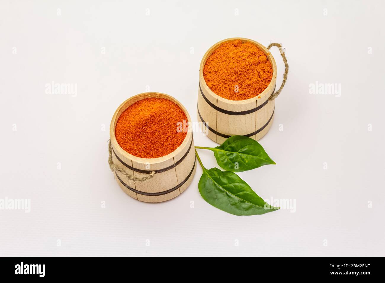 Two types of Hungarian paprika powder, hot and sweet, isolated on white ...