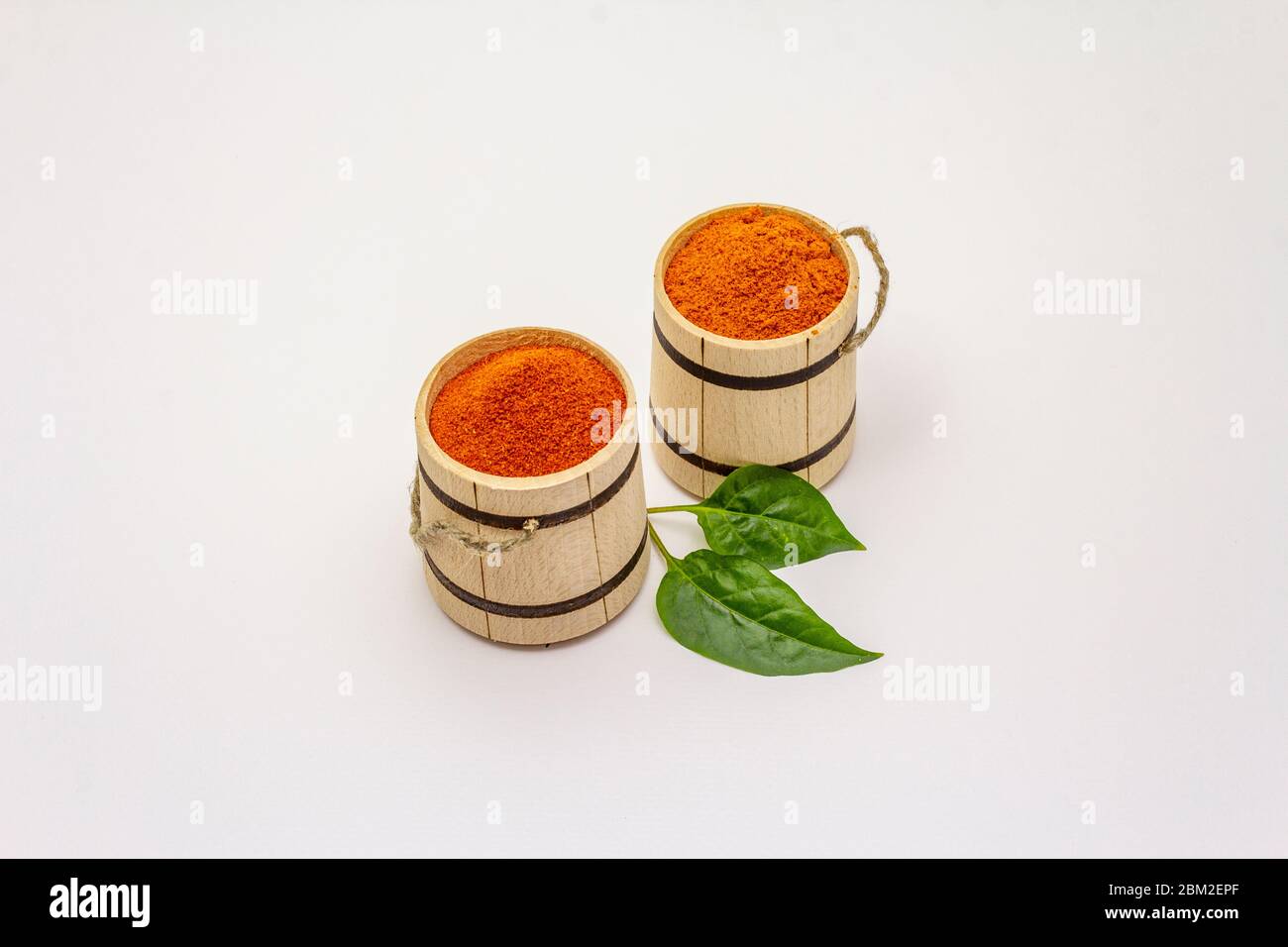 Two types of Hungarian paprika powder, hot and sweet, isolated on white ...