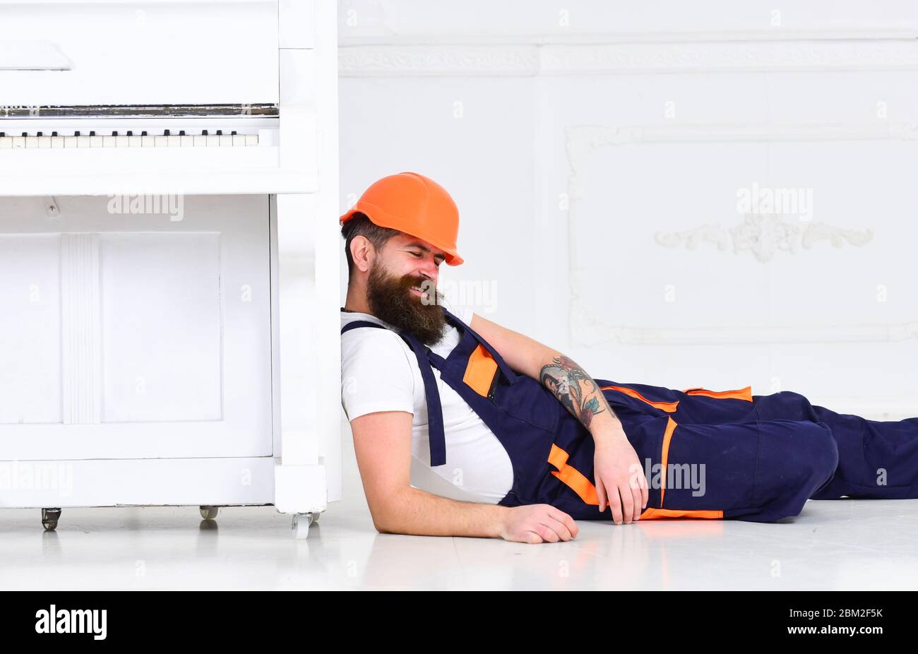 Tired mover lying on the floor due to lack of force. Guy having power ...