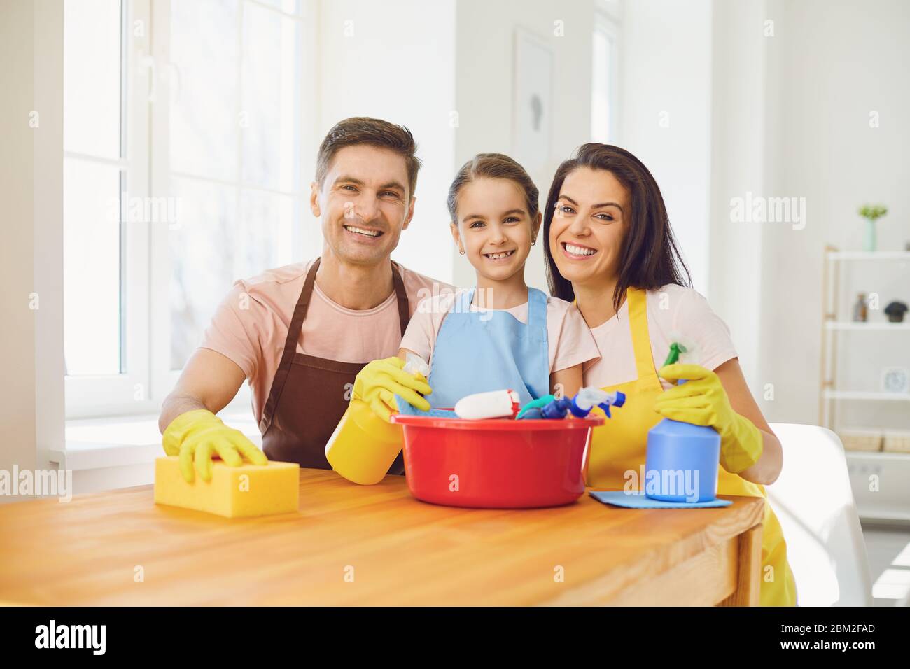 Happy family cleans the room in the house. Mother father and little ...