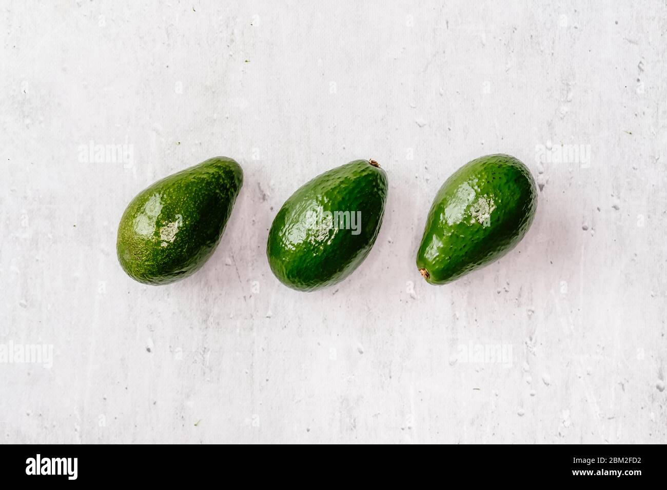 Three green avocado Stock Photo - Alamy