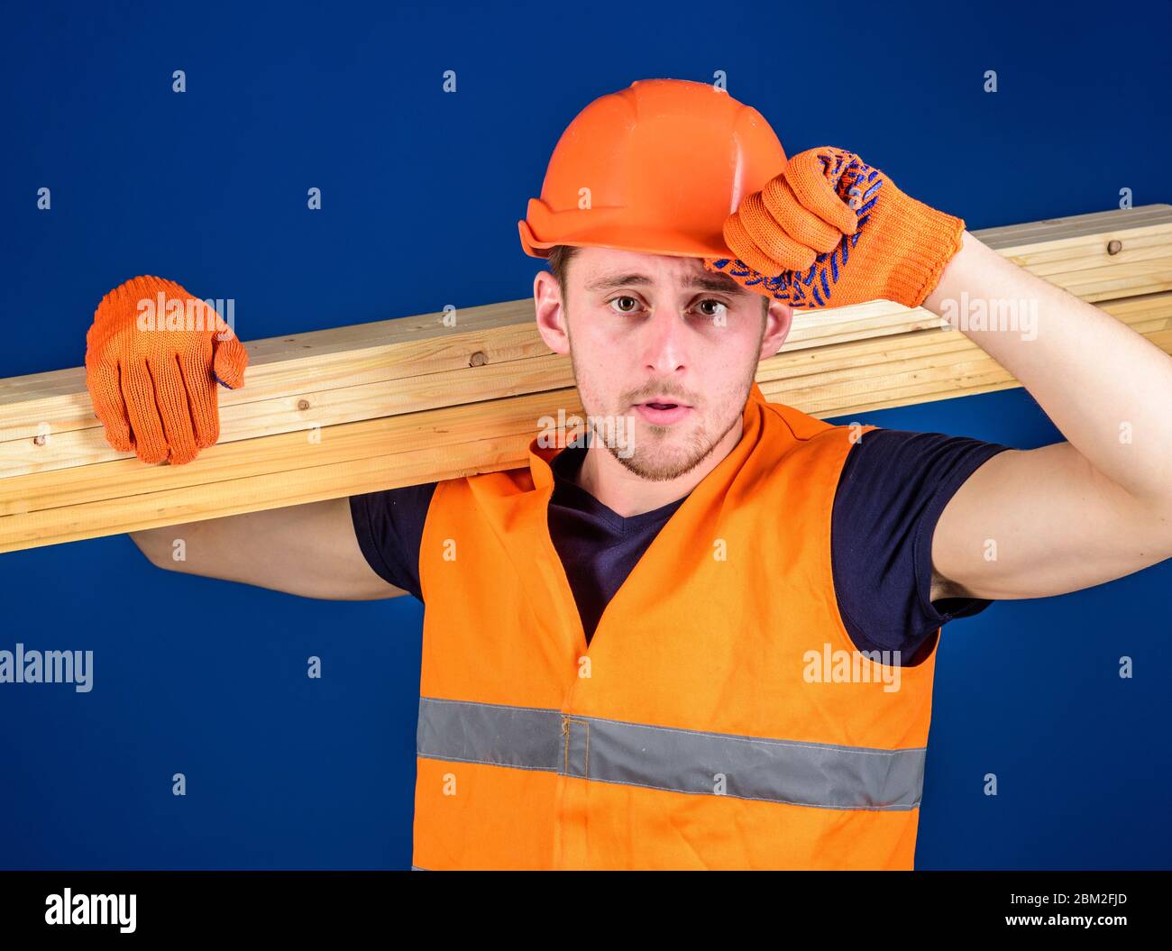 Male builder corrects hard hat hi-res stock photography and images - Alamy